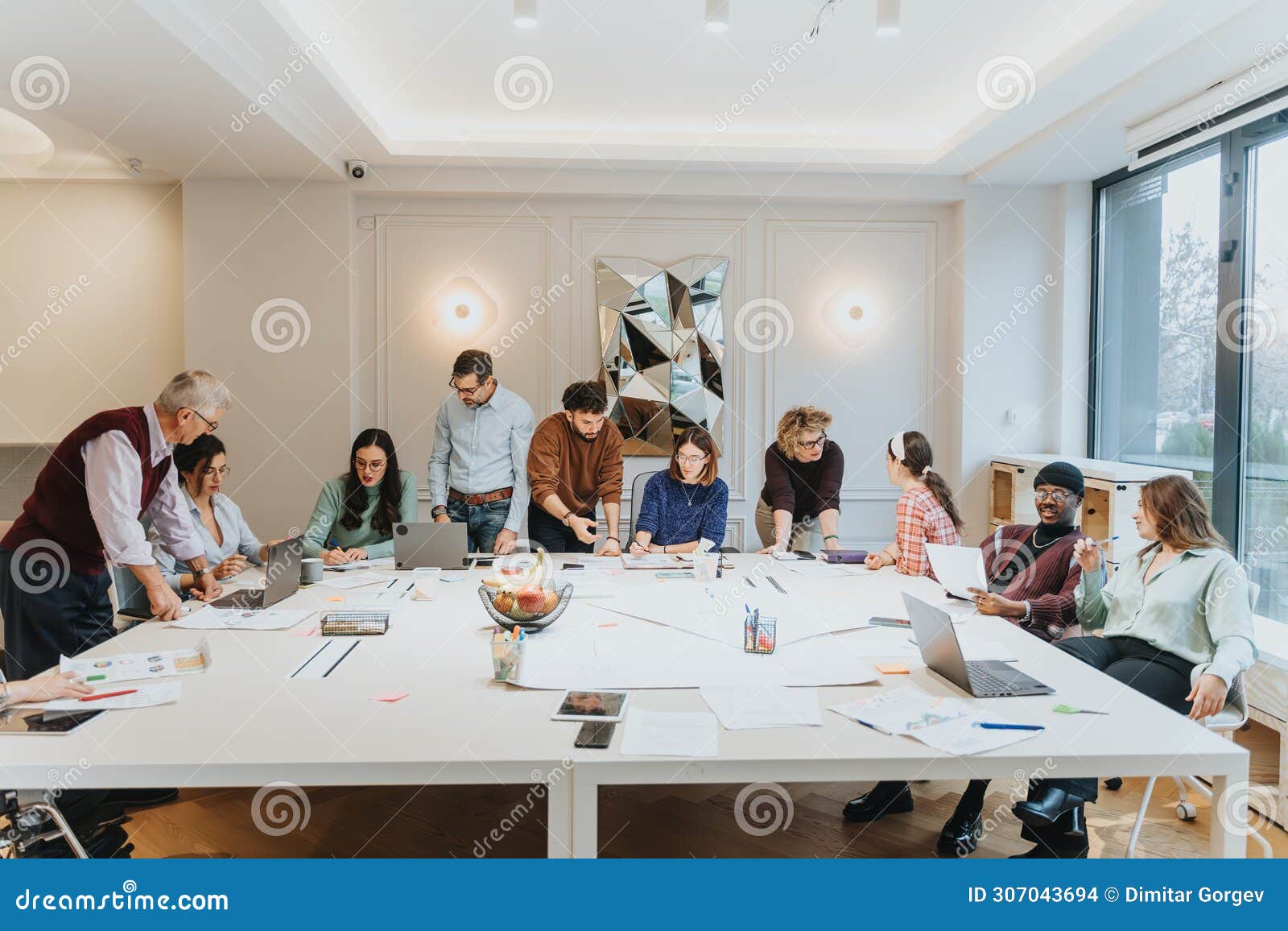 Inter Generational Team Engaging in Creative Workshop Discussion at ...