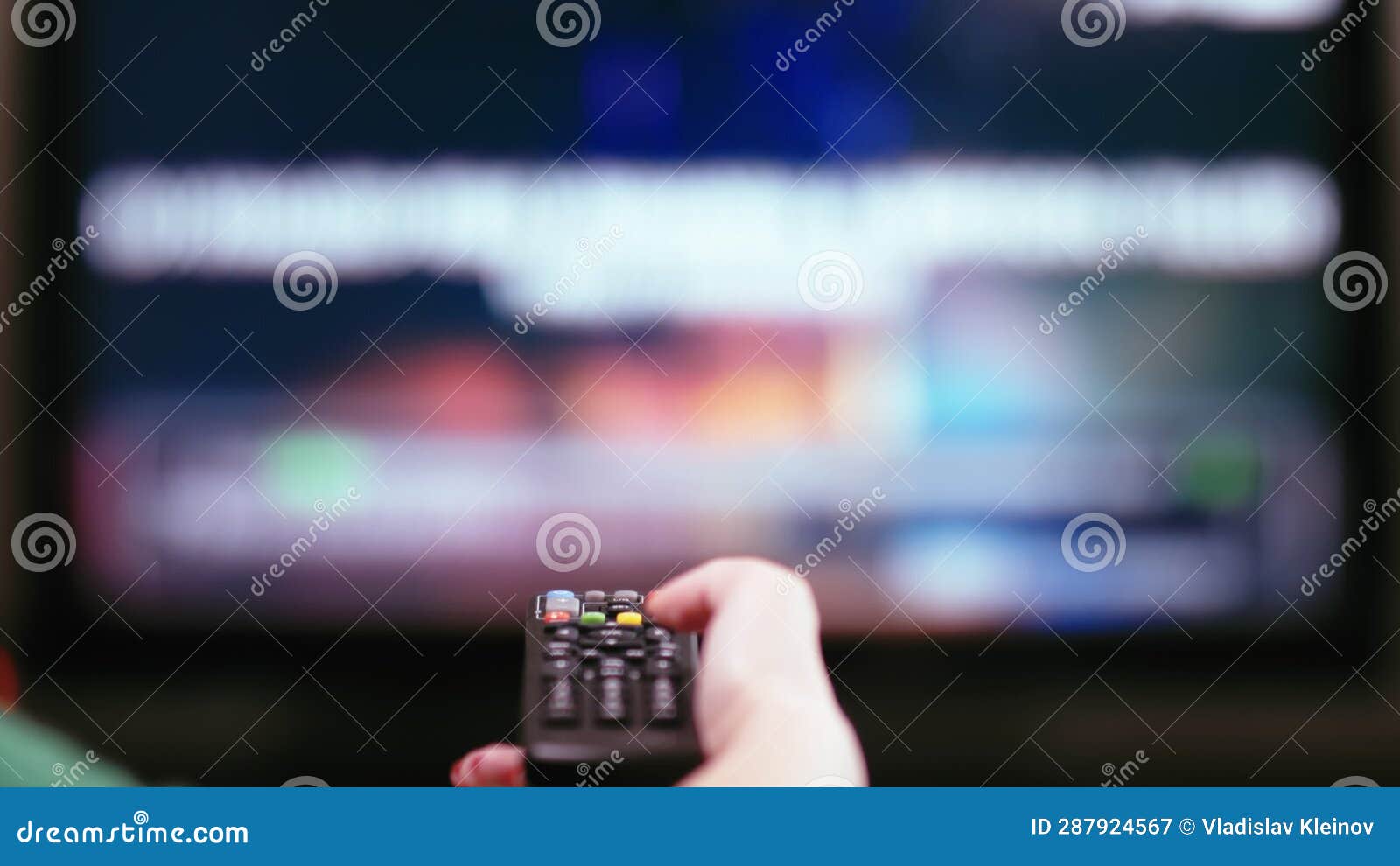 Interactive TV Experience: Close-Up Hand Operating Remote Control and ...