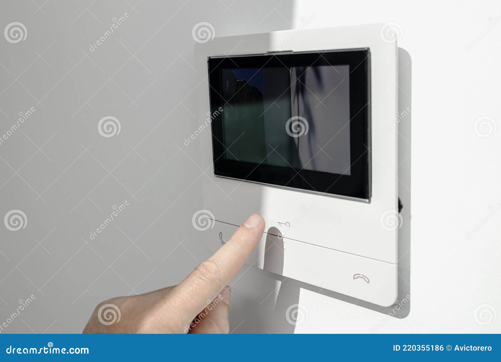 Intercom in Home Interior and a Hand Ready To Open the Door Button ...