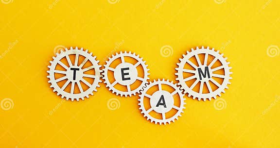 Interconnected Gears and the Word Team. Teamwork Concept. Stock Image ...