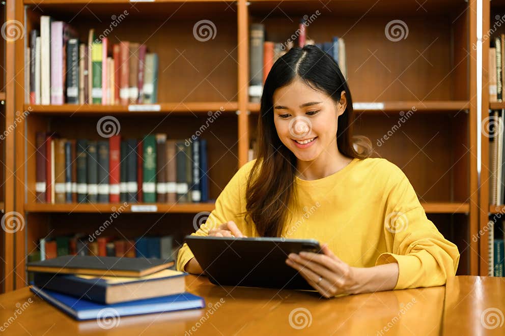 Interested Asian Female Student Using Digital Tablet, Doing Class ...