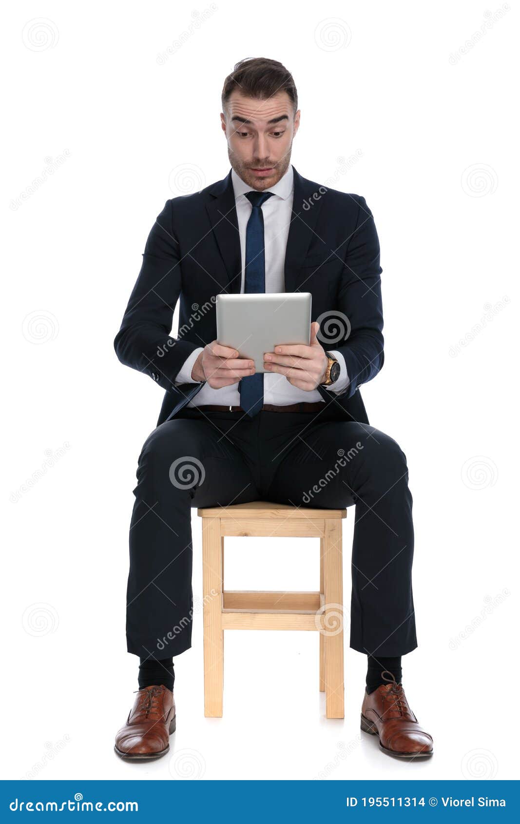 Interested Businessman Looking at Tablet and Smiling Stock Photo ...