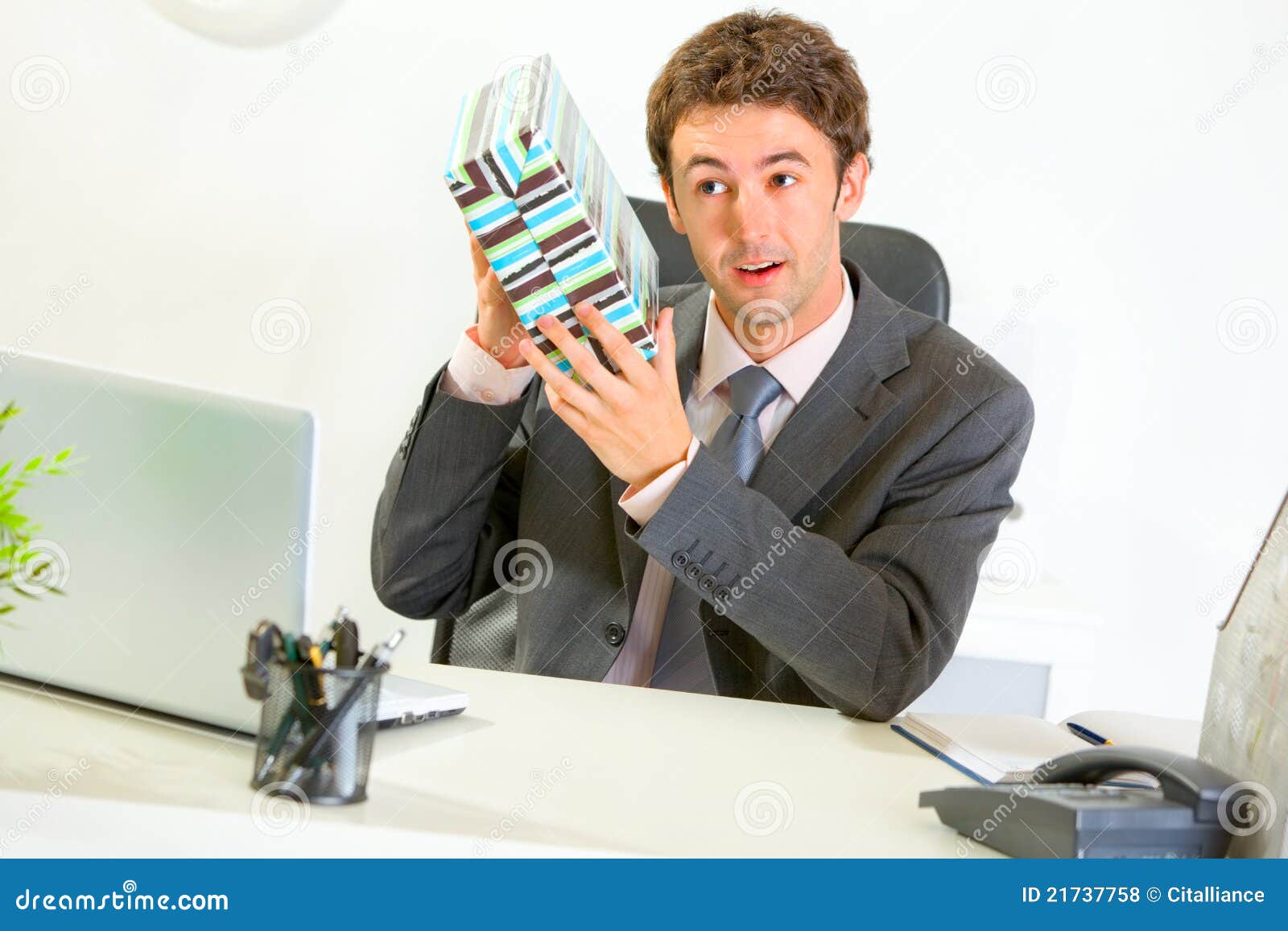 Interested Businessman Shaking Present Box Stock Photo - Image of ...