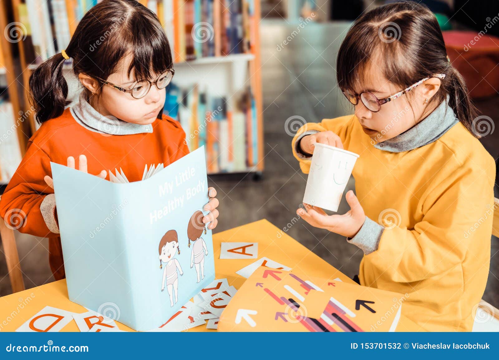 Interested Dark-haired Kids in Bight Outfits Being Involved in Learning ...