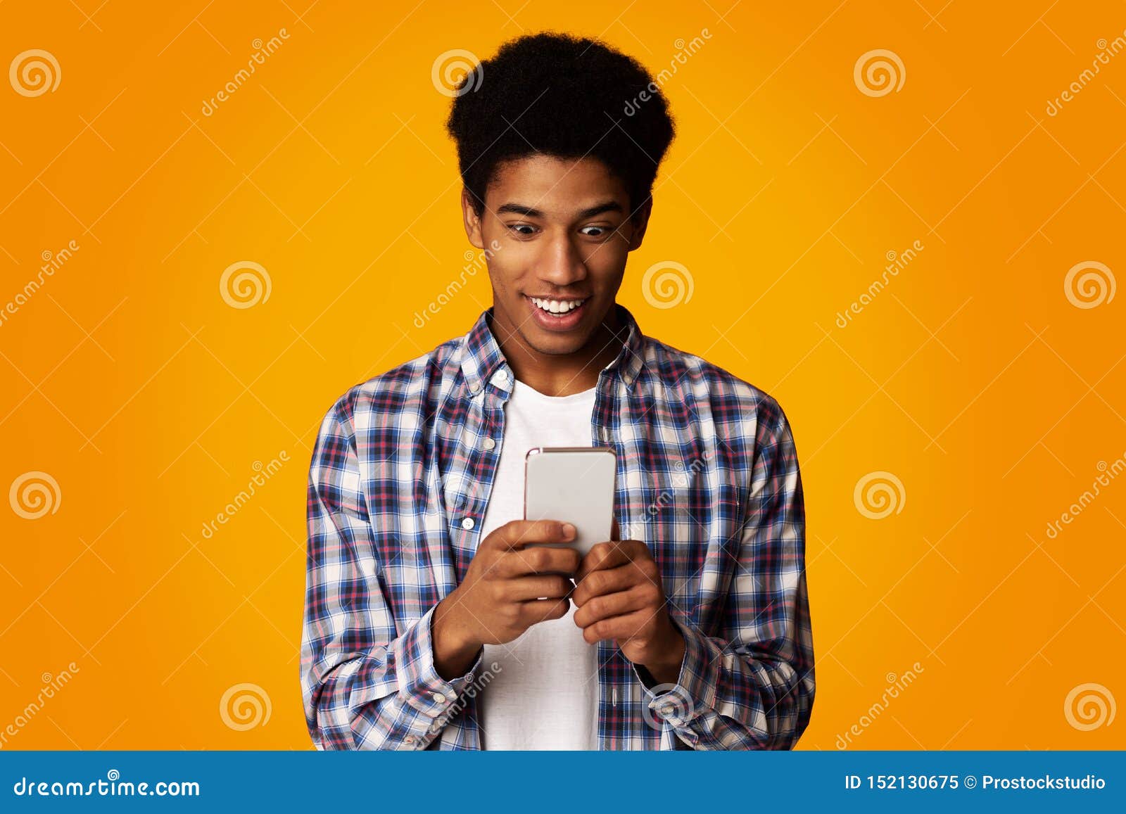 Interested Guy Using Smartphone on Yellow Background Stock Image ...