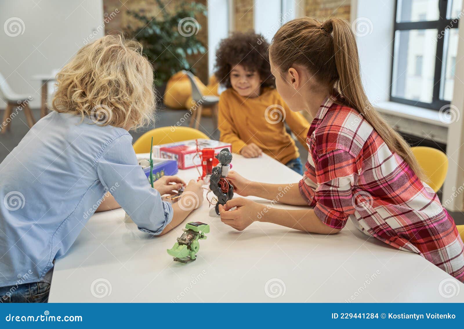 Interested in Technologies. Happy Children Examining, Looking at ...