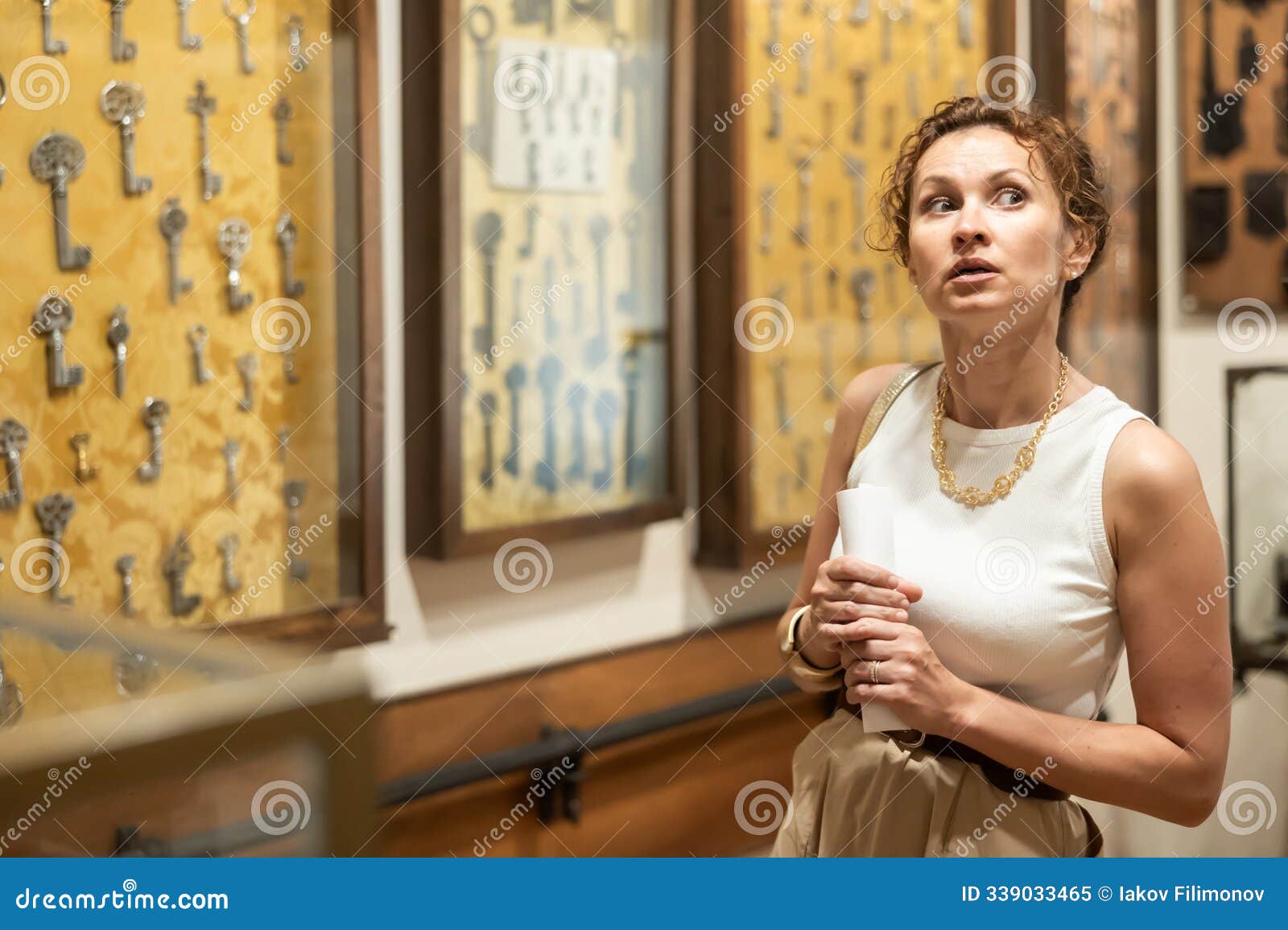 Interested Woman Looking at Collection of Medieval Sculptures and ...