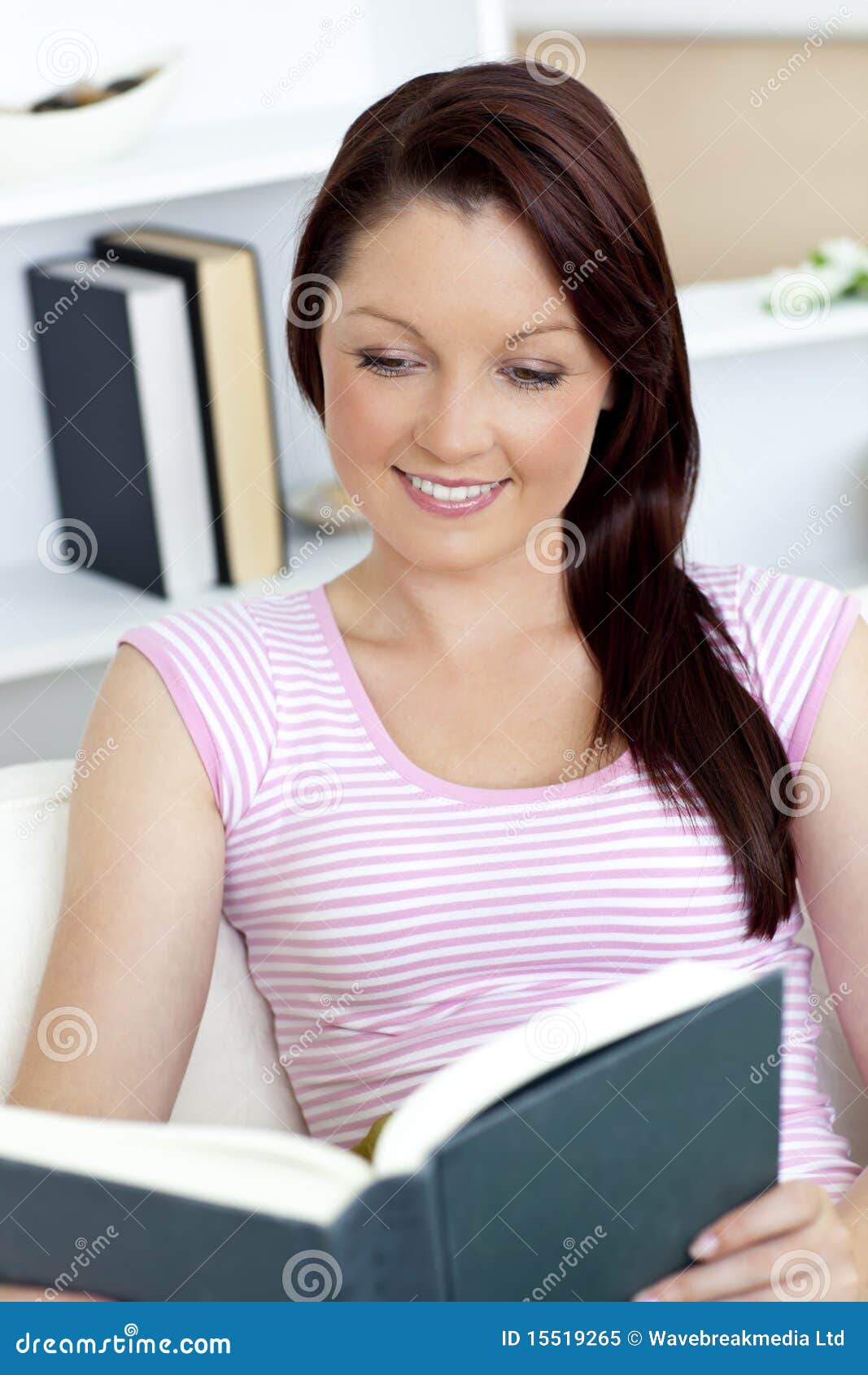 Interested Young Woman Reading a Book on the Sofa Stock Image - Image ...