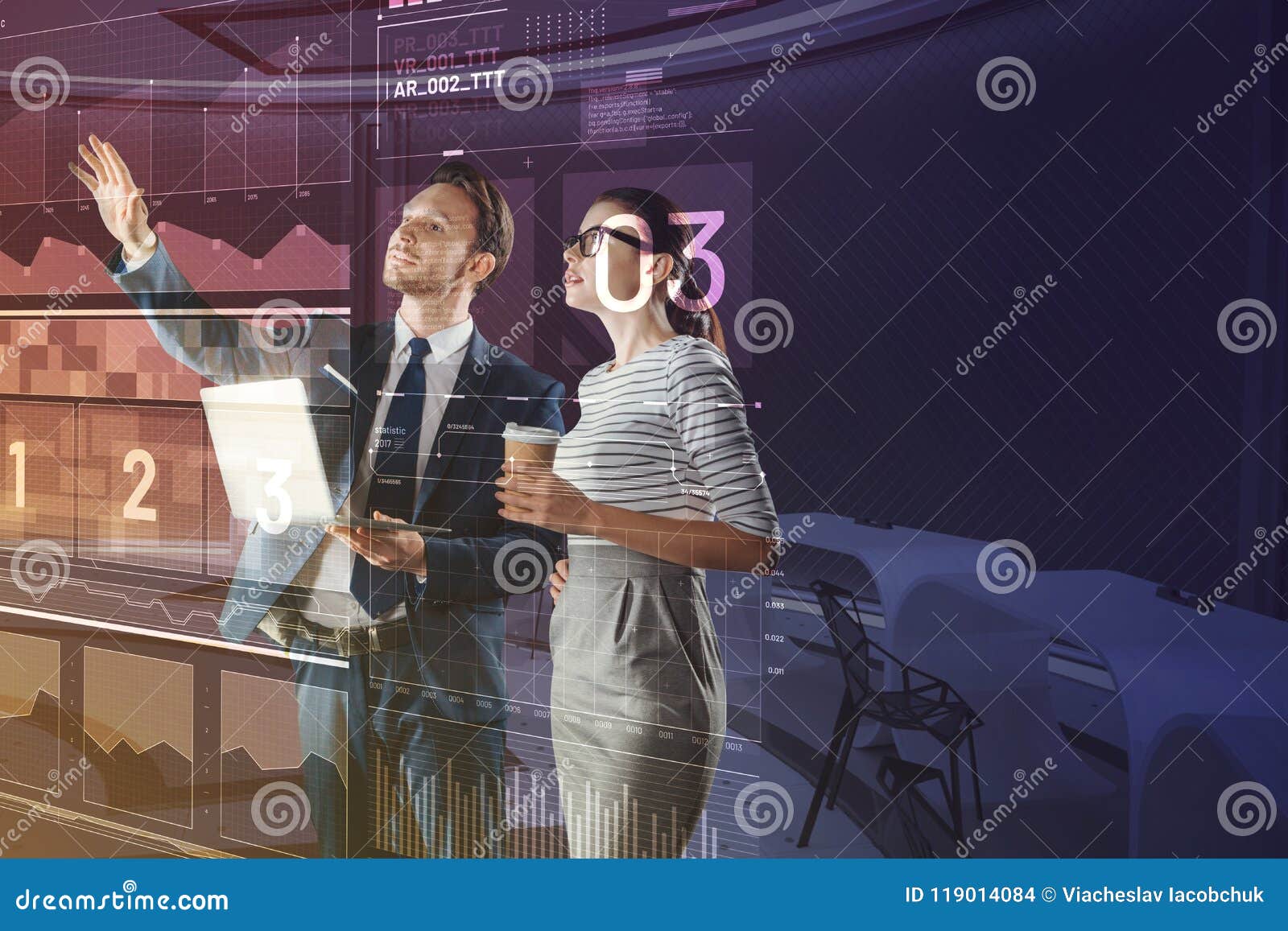 Young Man Pointing To the Screen and His Pretty Colleague Looking ...