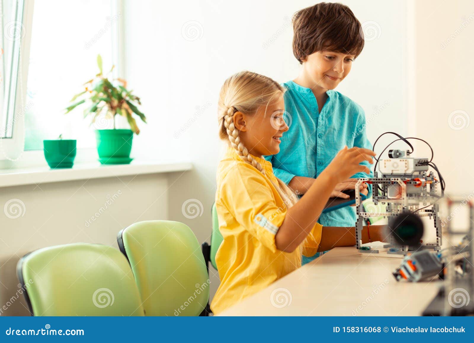 Two Classmates Playing with a Robot they Built. Stock Photo - Image of ...