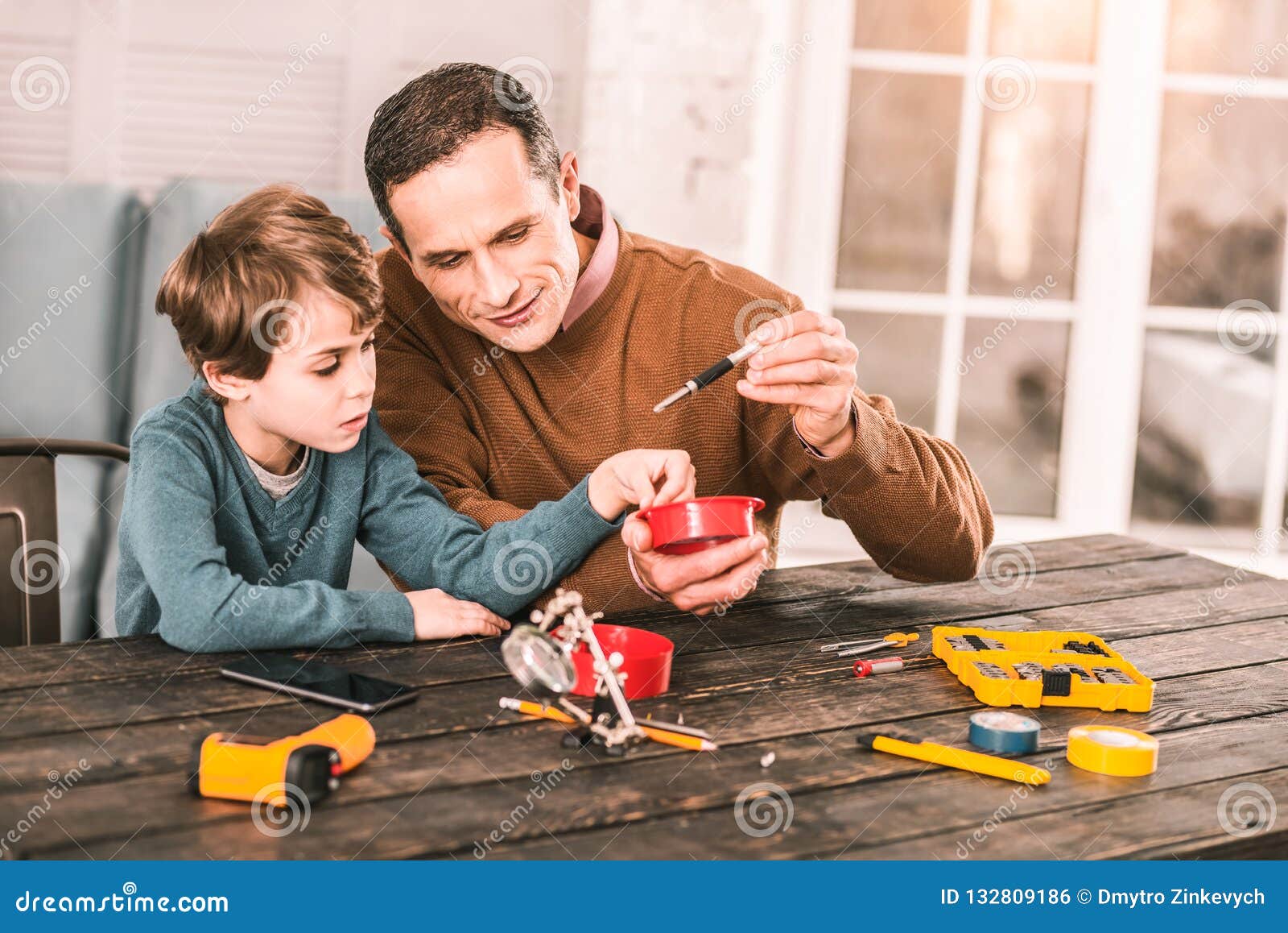 Smart Father and Son Tinkering with Some Curious Instruments. Stock ...