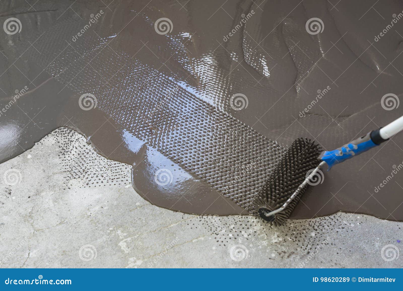 Spreading Self Leveling Plaster With A Special Roller. Interior Stock ...