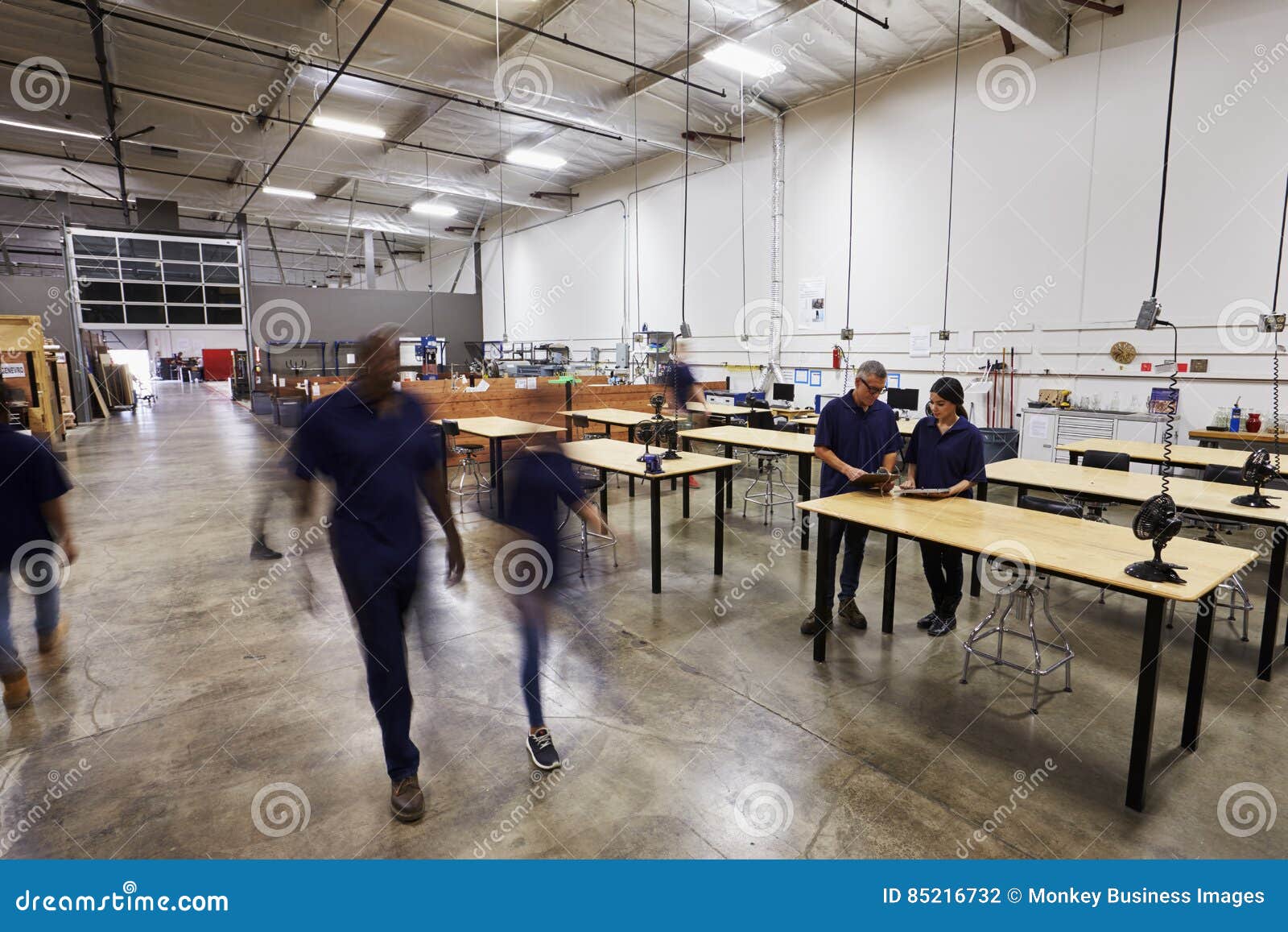 Interior of Busy Factory with Staff at Work Benches Stock Photo - Image ...