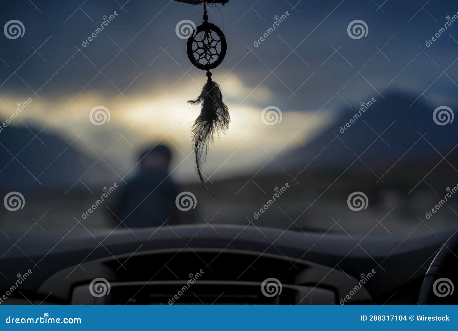 Interior of a Car Featuring a Dream Catcher Draping from the Windshield ...