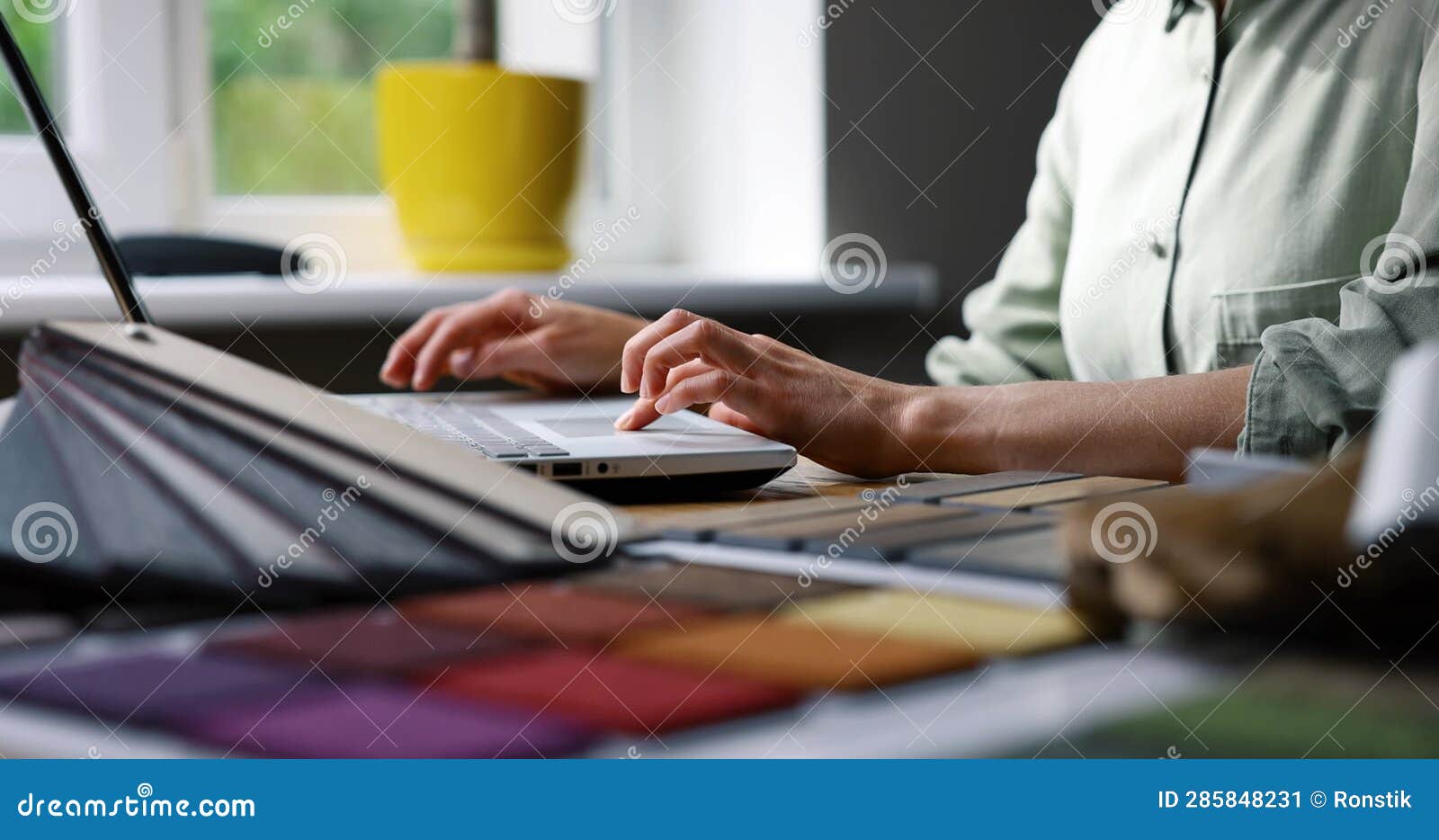 Interior Designer Working on Laptop in Office. Design Material Samples ...