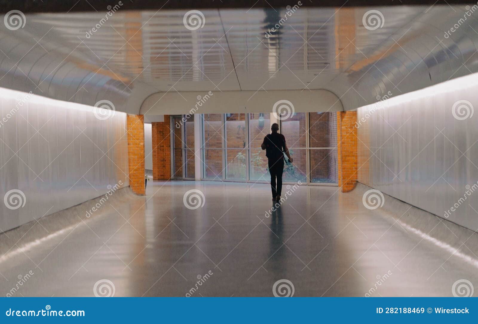 Interior Hallway Featuring a Human Figure Walking through it Stock ...