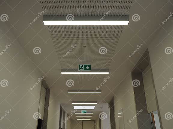 Interior Hallway with a Sign Pointing To the Exit. Stock Photo - Image ...