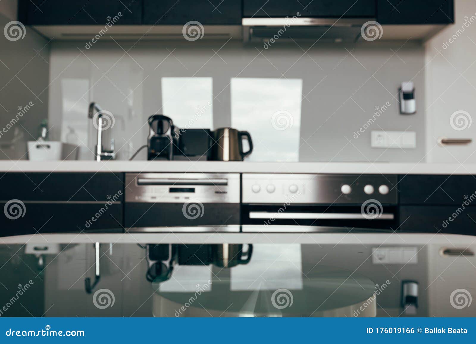 Interior of a Kitchen. Focus in Front on the Glass Table with Blurred ...