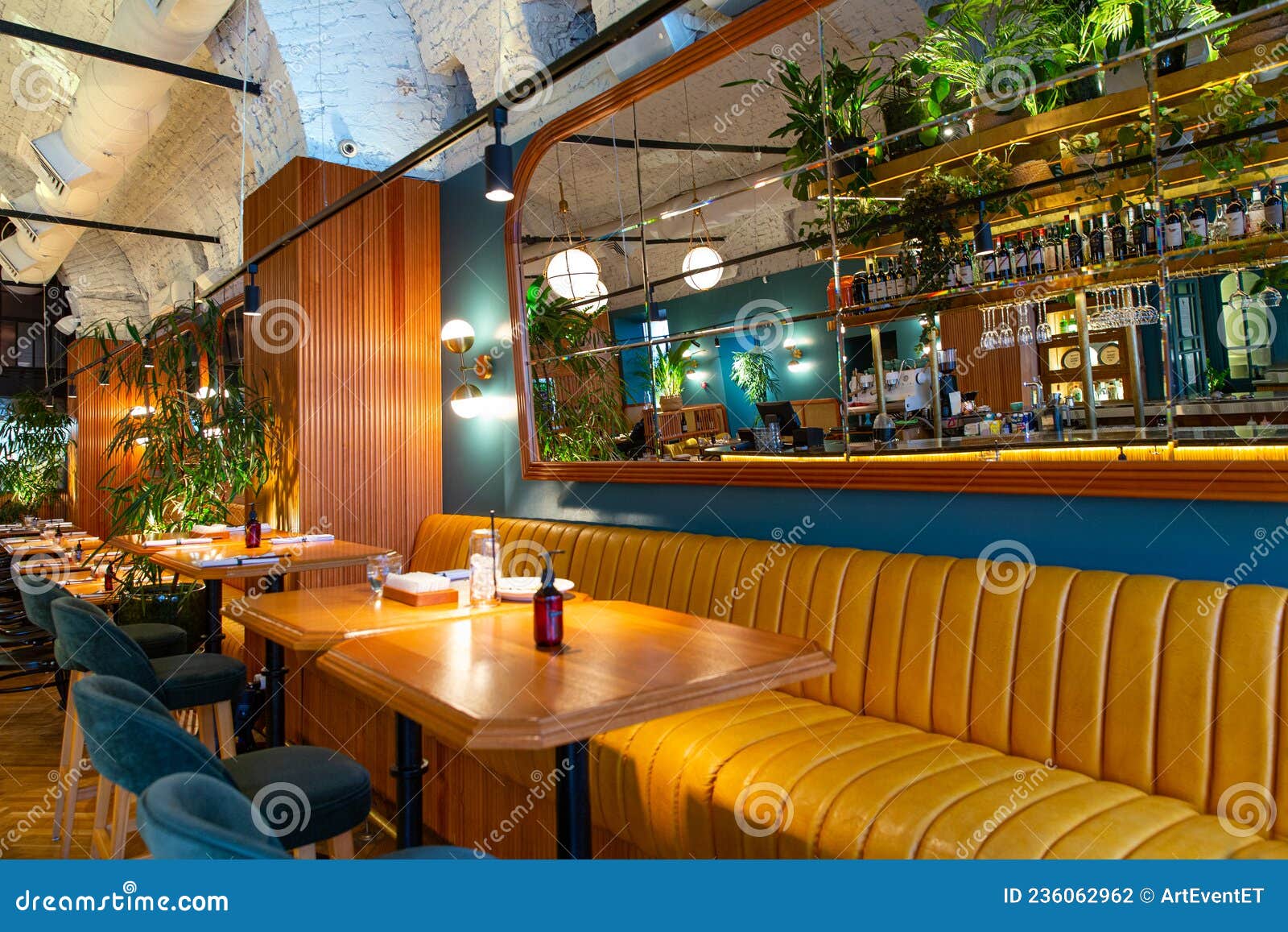 Interior of Modern Loft Style Restaurant with Fresh Flowers and Mirror ...