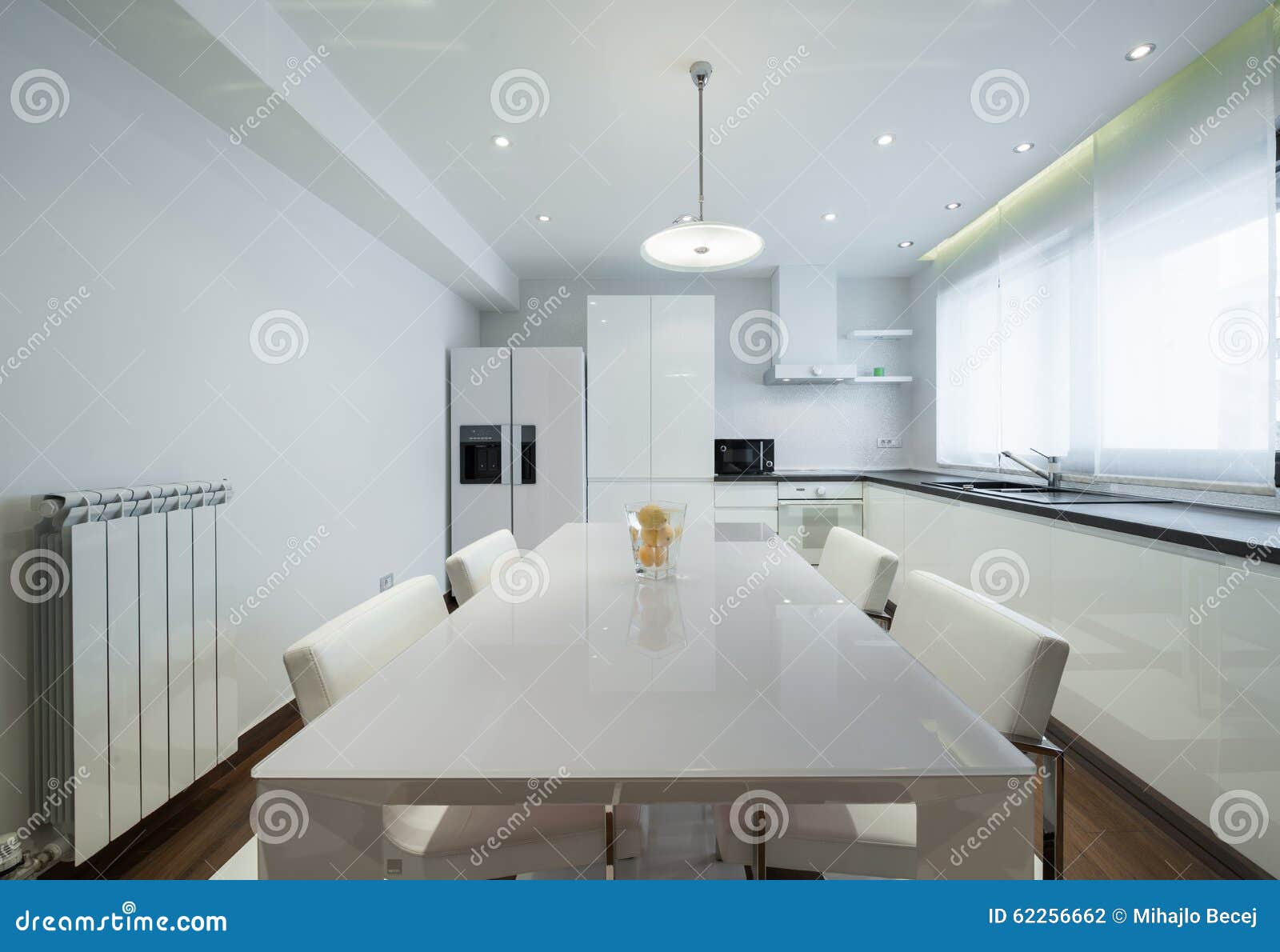 Interior of a Modern Luxury Bright White Kitchen with Dining Tab Stock ...