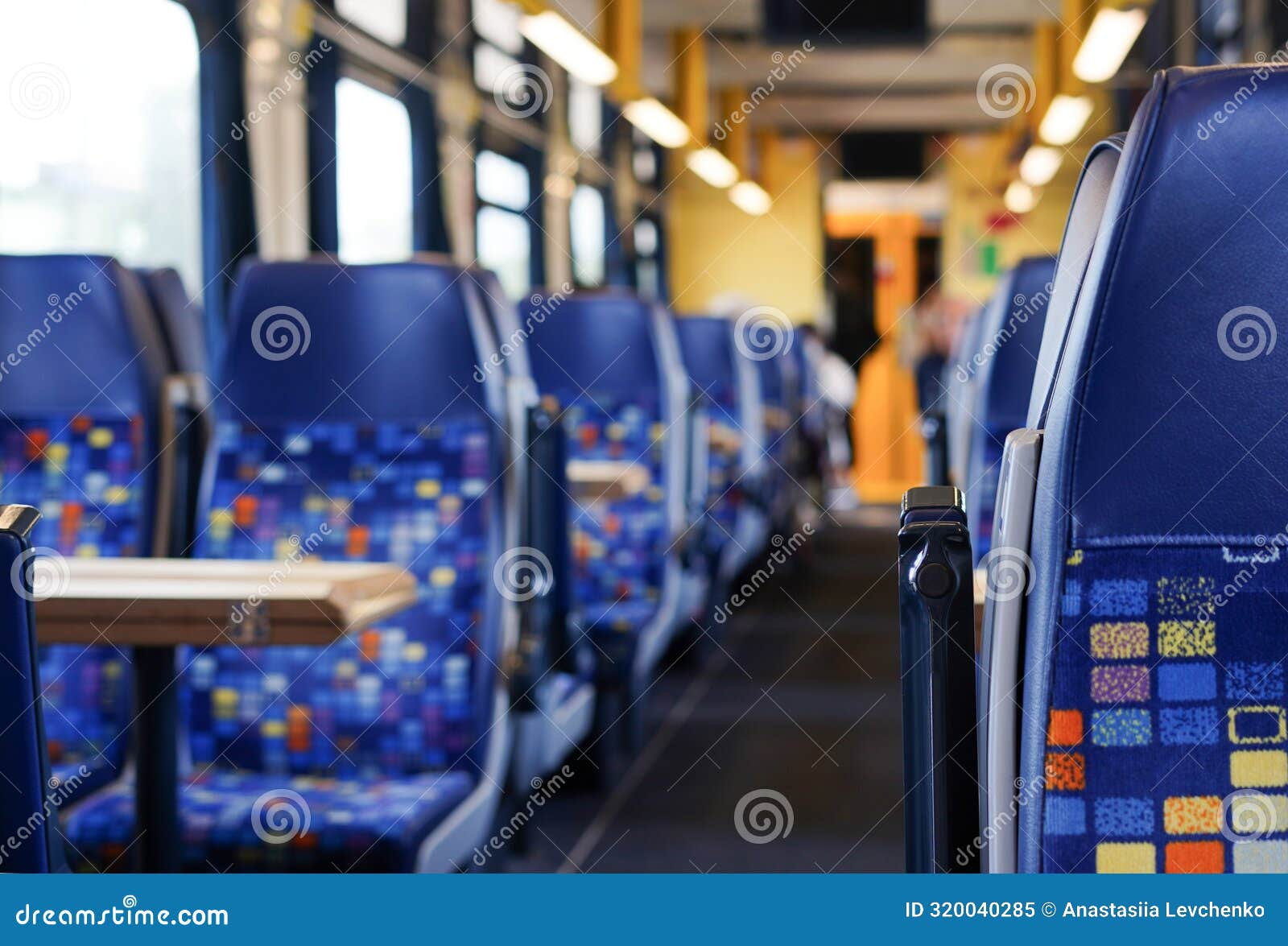 Interior of a Modern Train or Bus with Rows of Blue Seats, and a ...