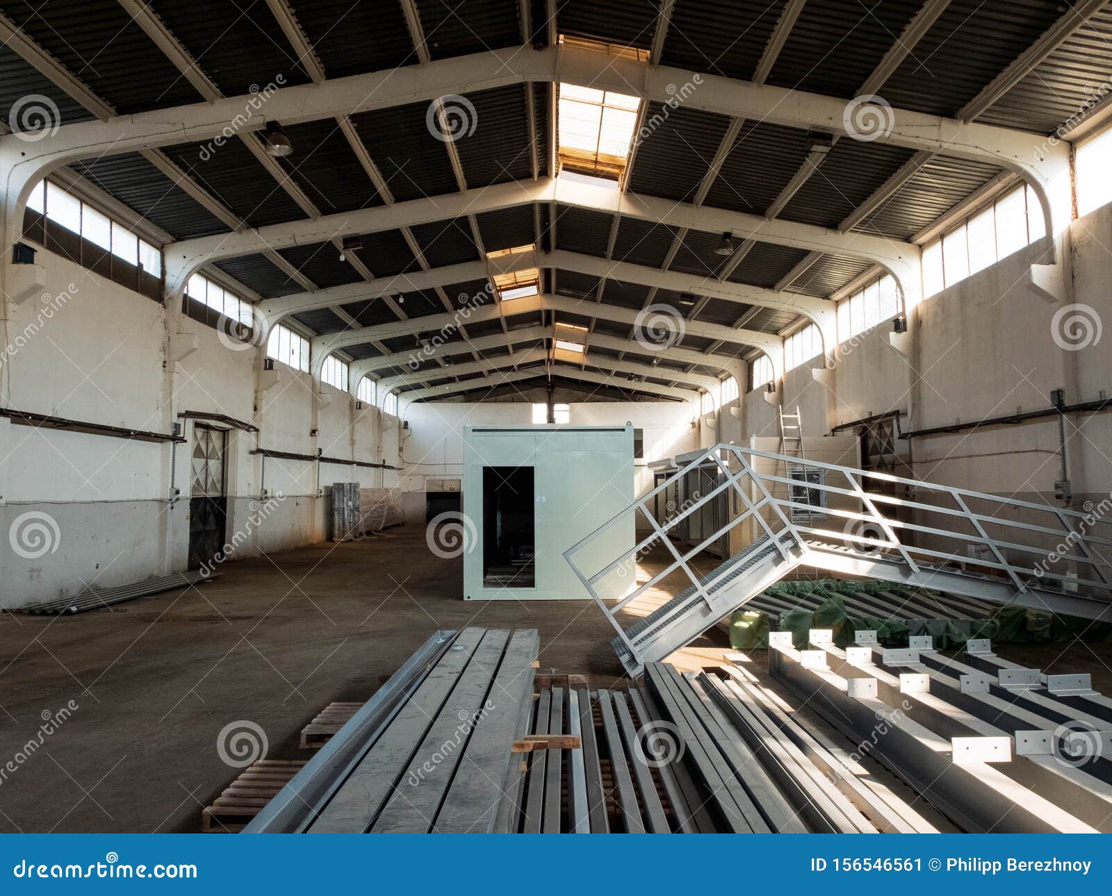 Interior of the Old Warehouse with Piled Construction Materials Stock ...