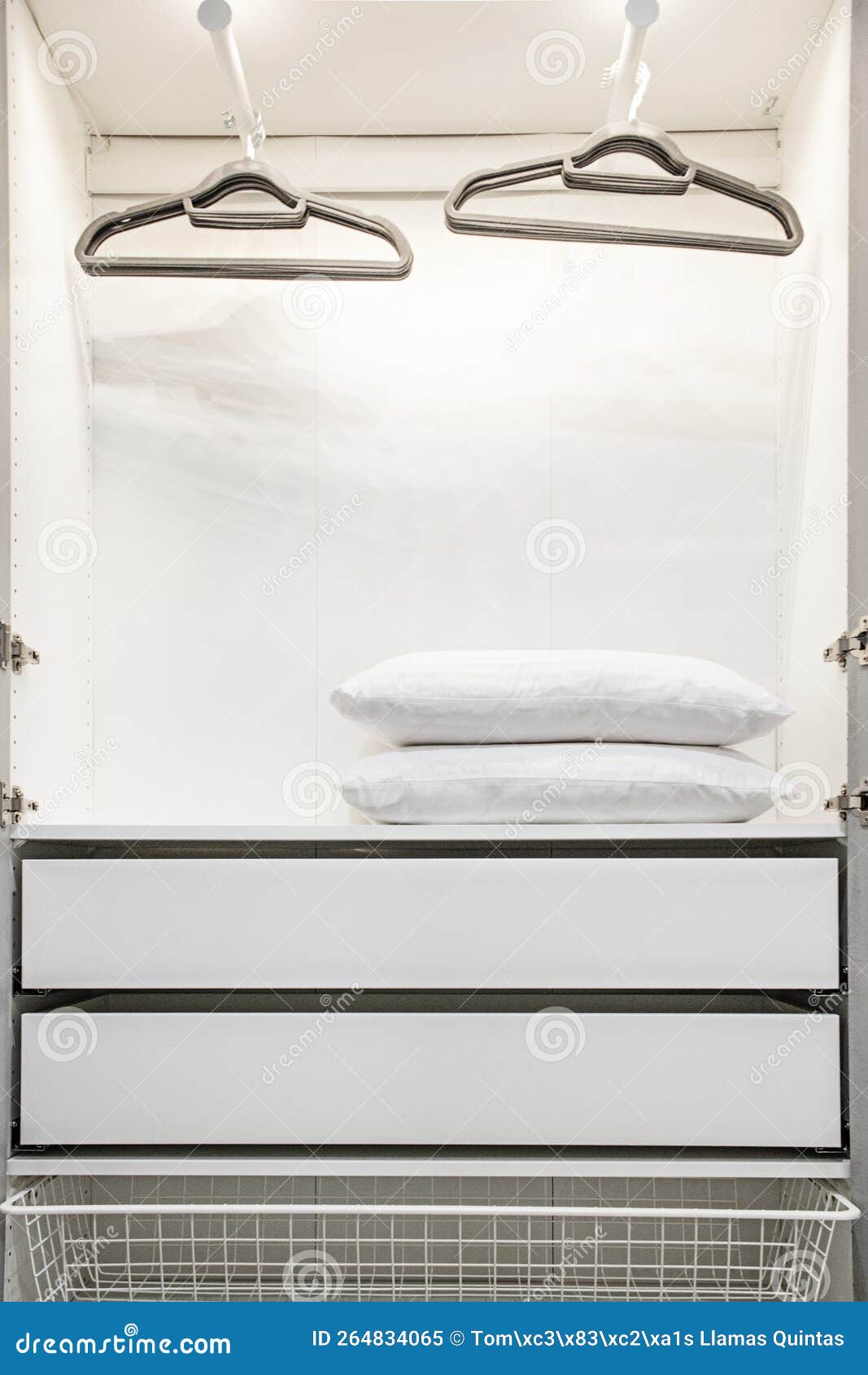 Interior of an Open Closet with White Doors, Shirt Racks, White Pillows ...