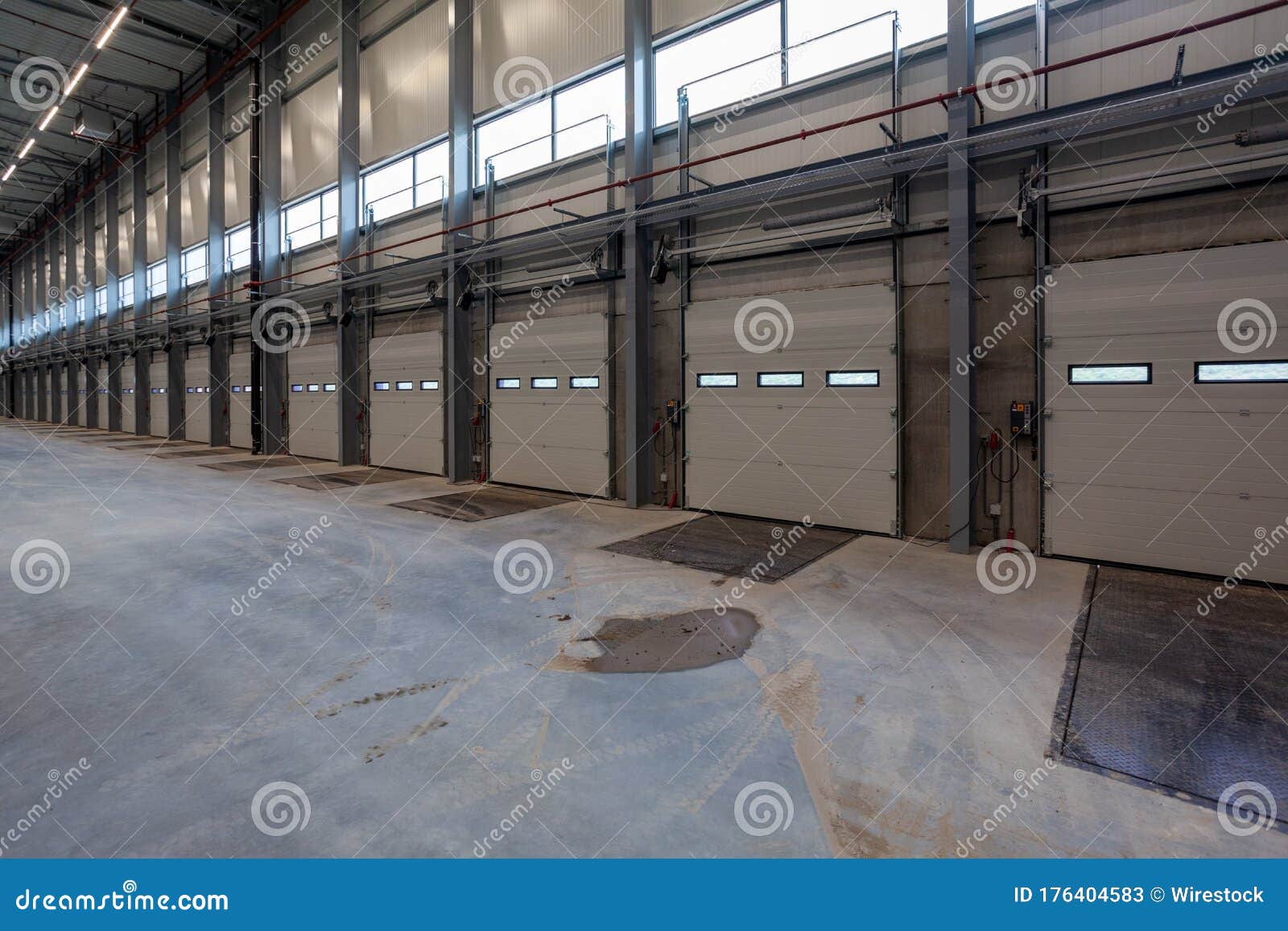 Interior Shot of a Warehouse with a Large Row of Loading Doors Stock ...
