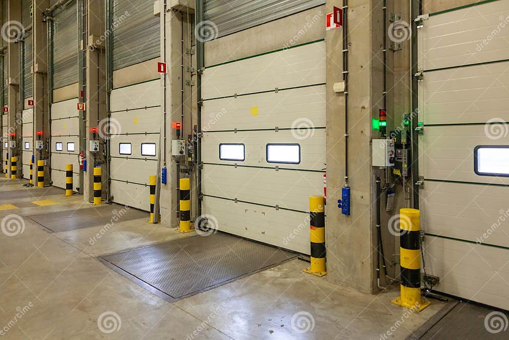 Interior Shot of a Warehouse with a Row of Doors and Control Panels ...