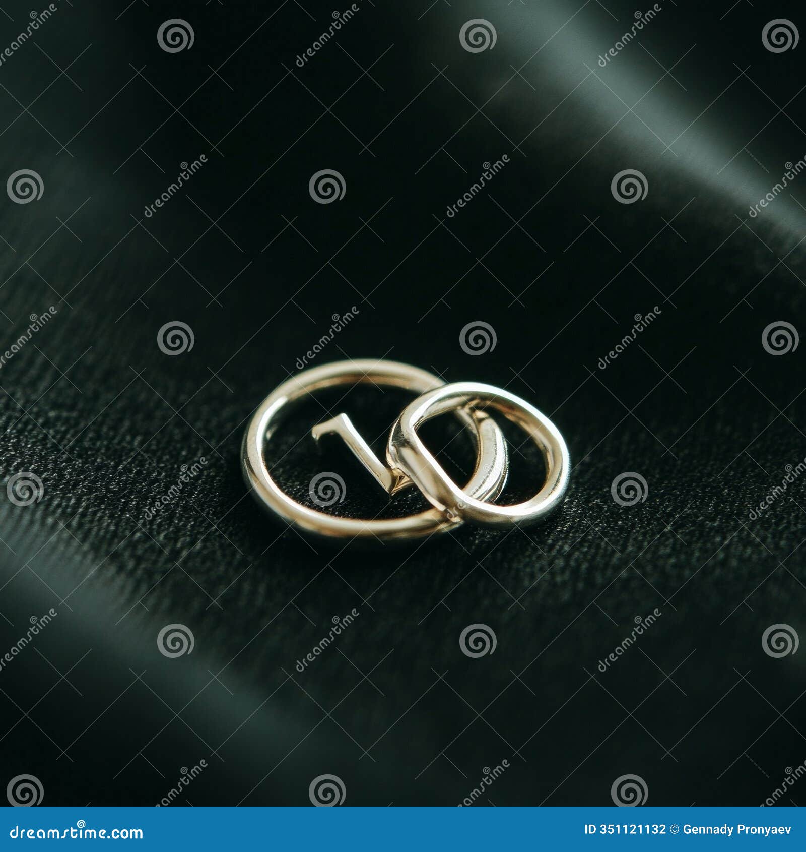 Interlocking Gold Rings on Smooth Dark Fabric Background Stock Photo ...