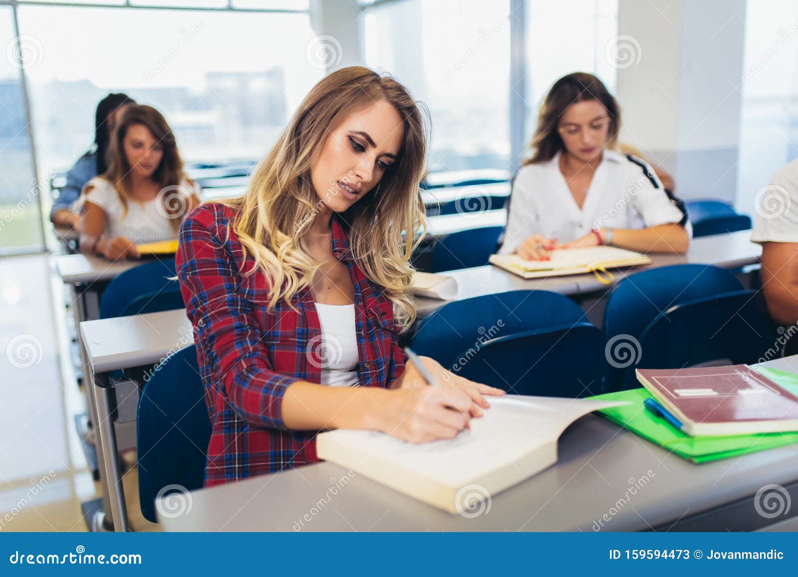 International Students Writing in Lecture Hall and Talking Stock Image ...