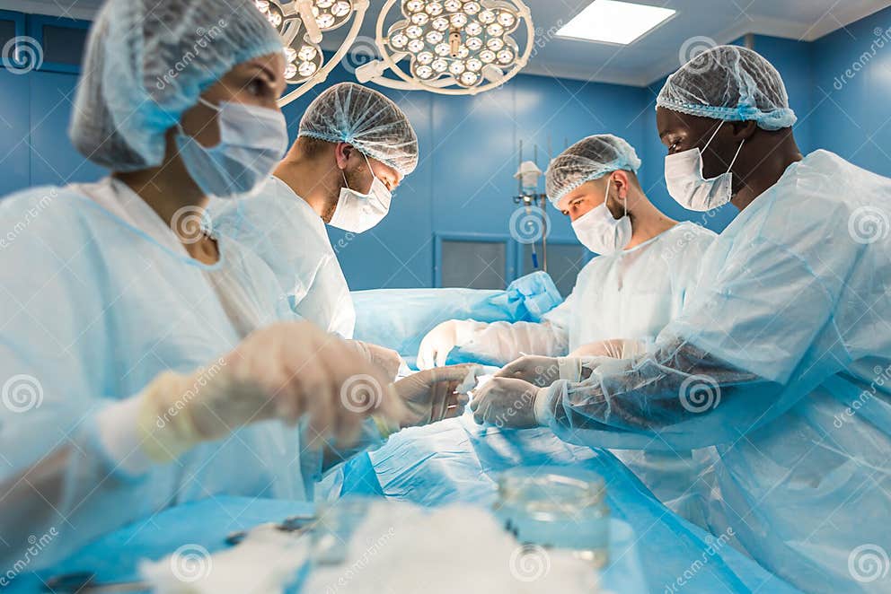 An International Team of Doctors Performs a Complex Surgical Operation ...