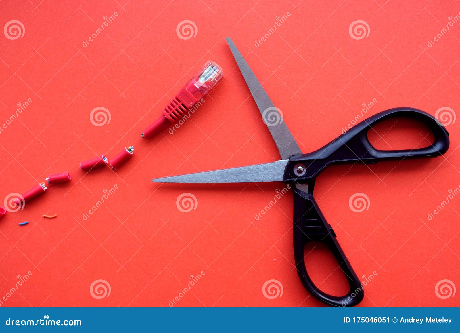 Internet Cable Cut into Pieces by Metal Office Scissors on a Red ...