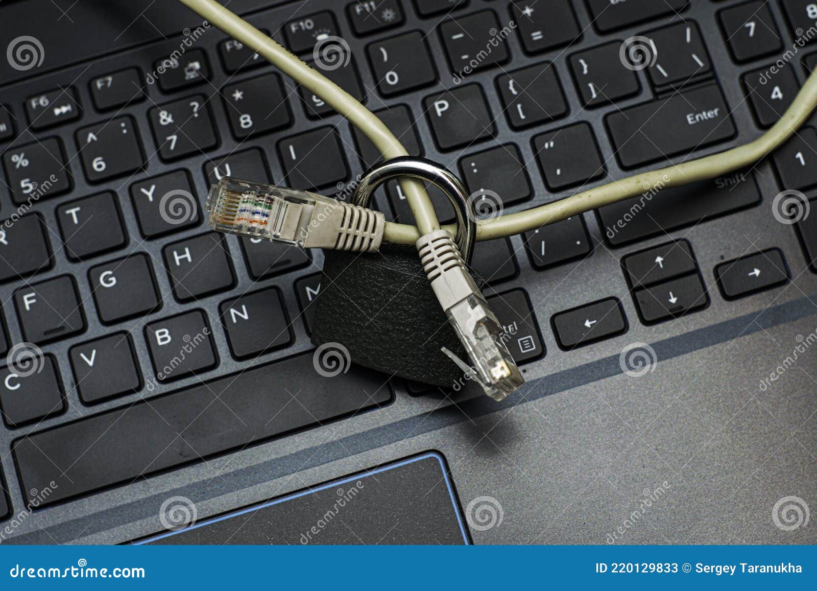 Internet Cable Passing through a Closed Iron Lock on a Laptop Keyboard ...