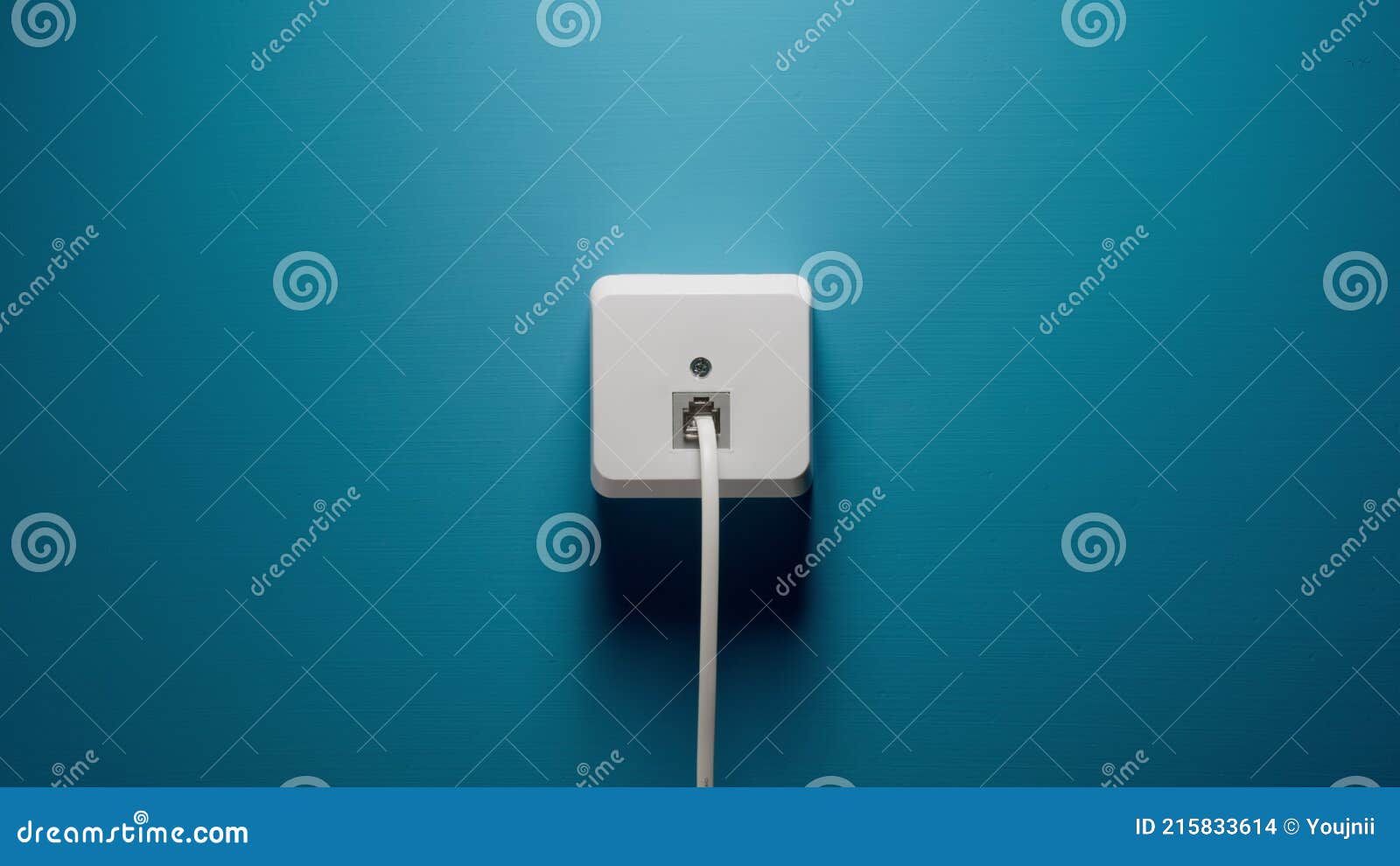 Internet Cord into Wall Socket on a Blue Wall Stock Photo - Image of ...
