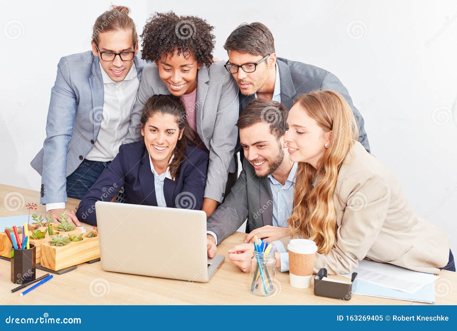 Internet Start-up Team Looks Together on Laptop Stock Image - Image of ...