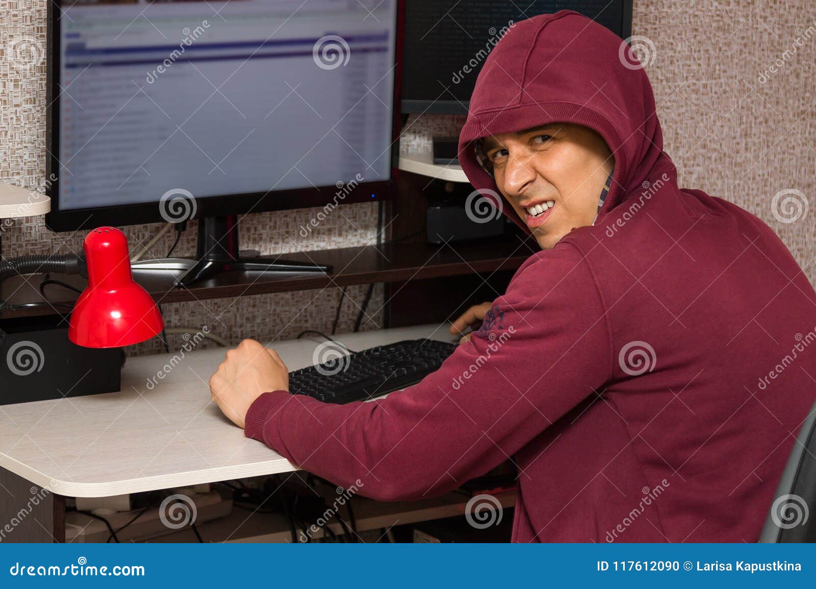 Internet Troll with the Evil Face Sitting at the Computer. Irritated ...