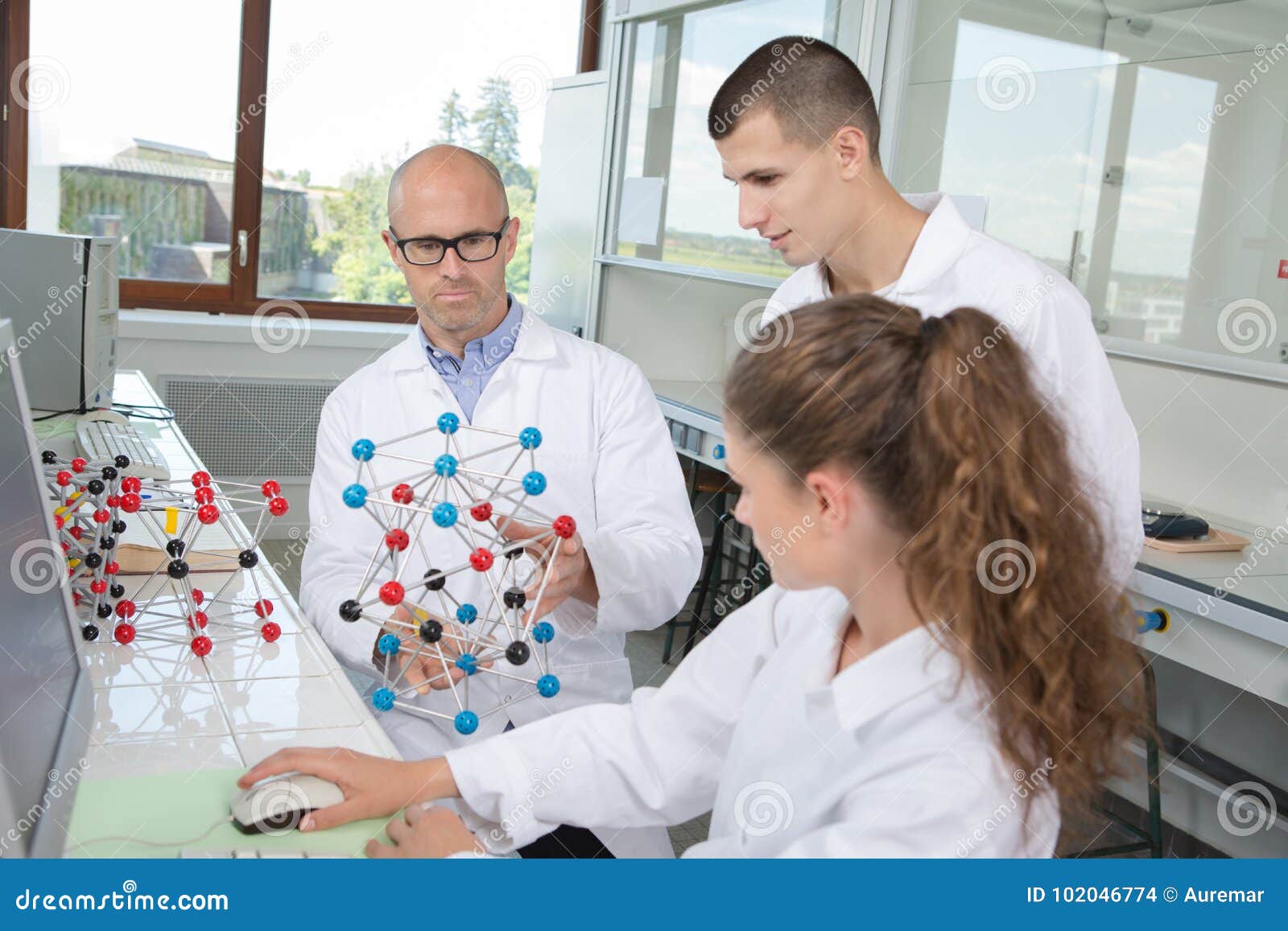Interns in Lab with Atoms Model Stock Photo - Image of internship ...