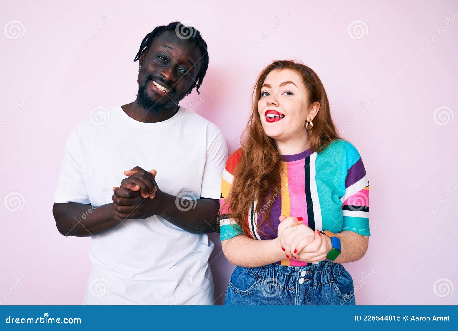 Interracial Couple Wearing Casual Clothes With Hands Together And