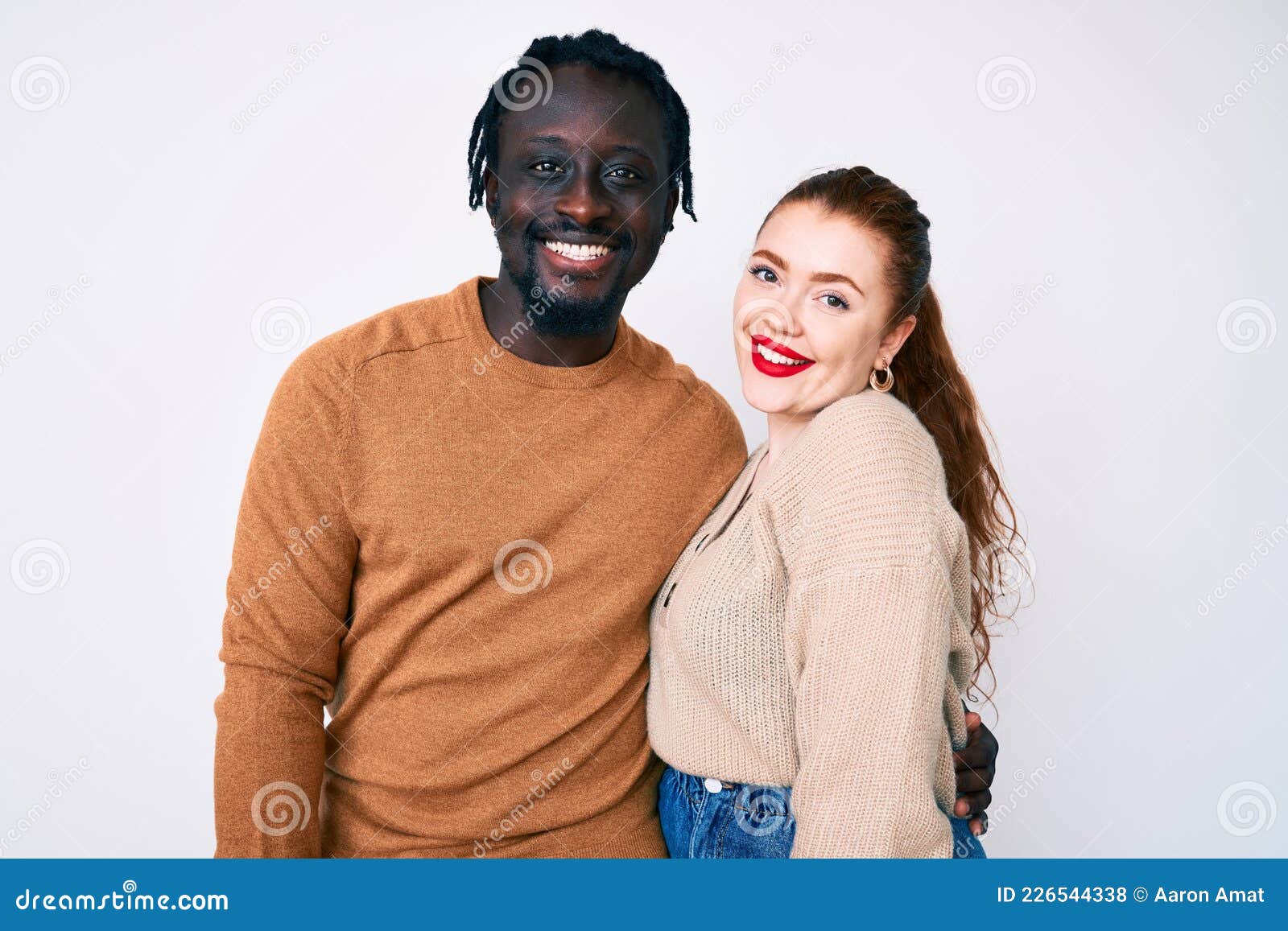 Interracial Couple Wearing Casual Clothes With A Happy And Cool Smile