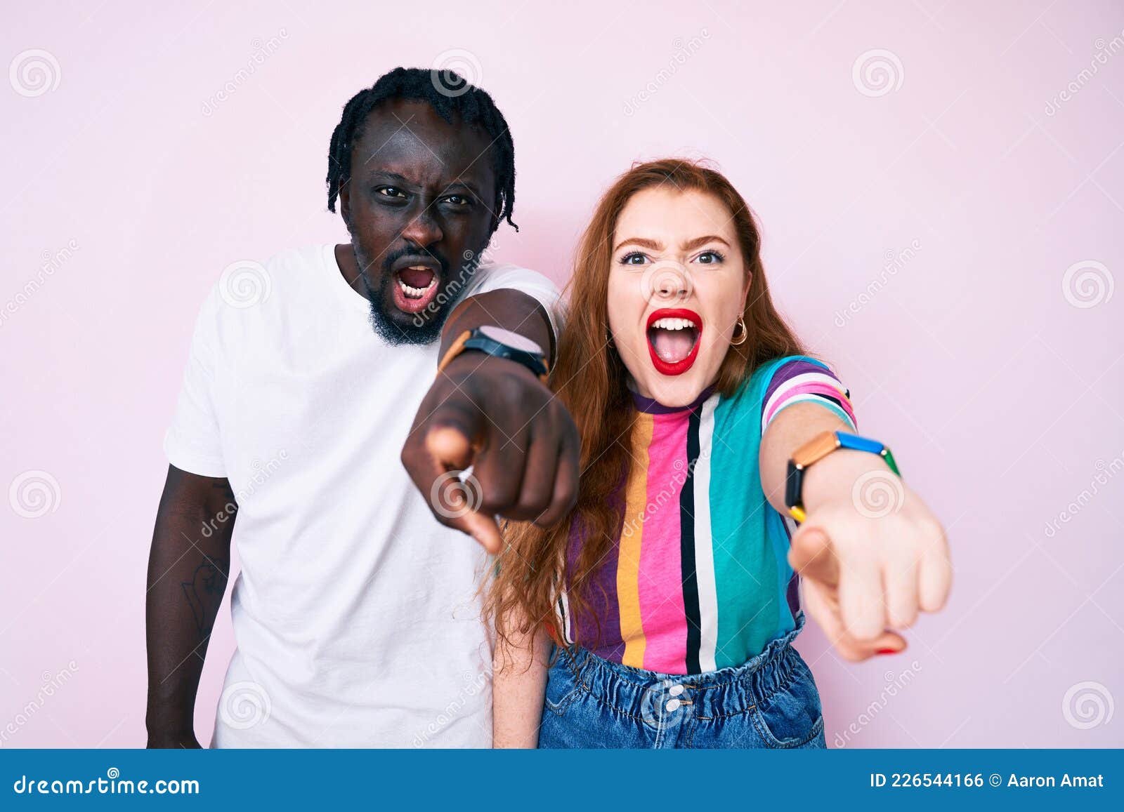 Interracial Couple Wearing Casual Clothes Pointing Displeased And