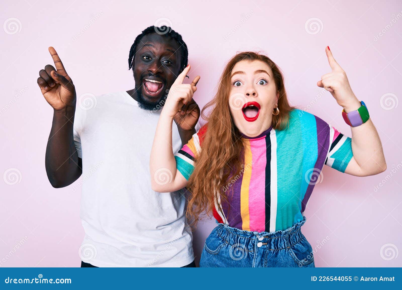 Interracial Couple Wearing Casual Clothes Smiling Amazed And Surprised