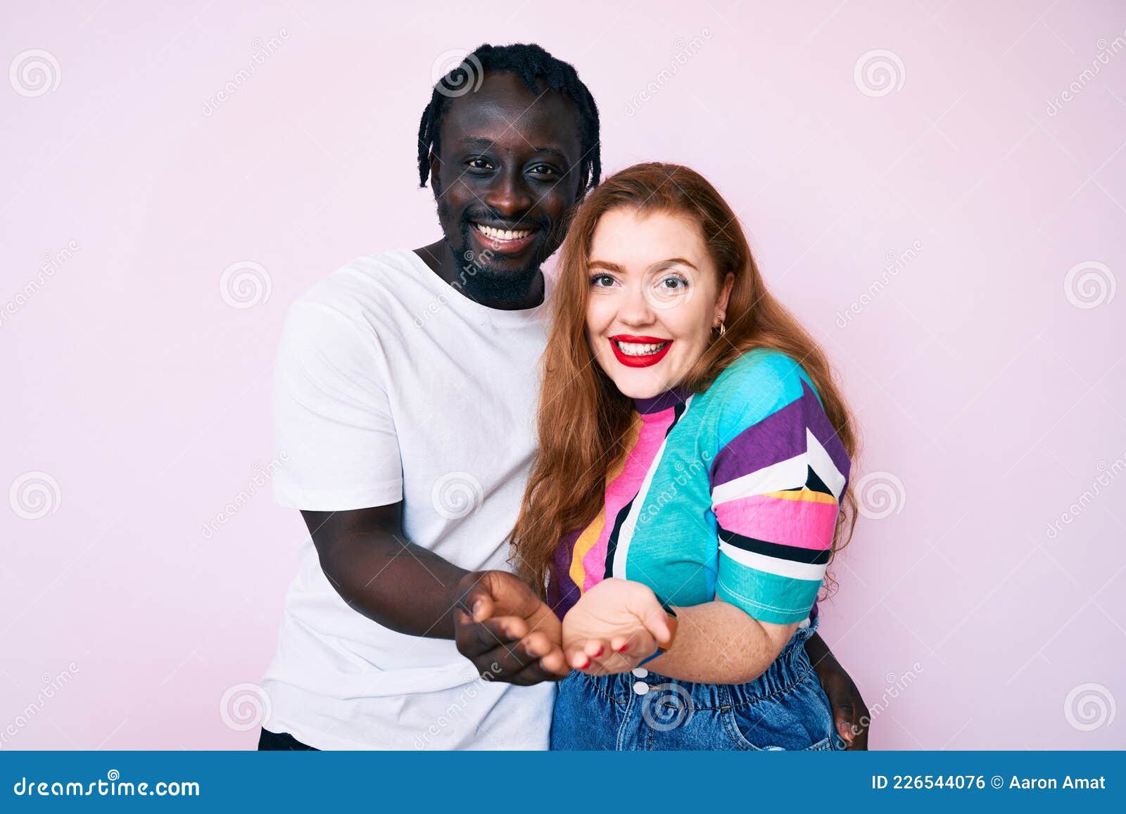 Interracial Couple Wearing Casual Clothes Smiling With Hands Palms