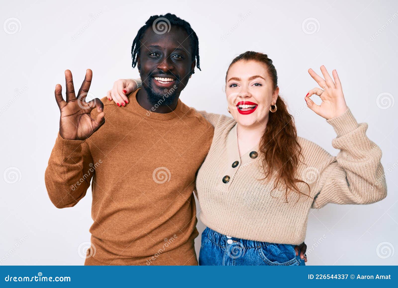 Interracial Couple Wearing Casual Clothes Smiling Positive Doing Ok