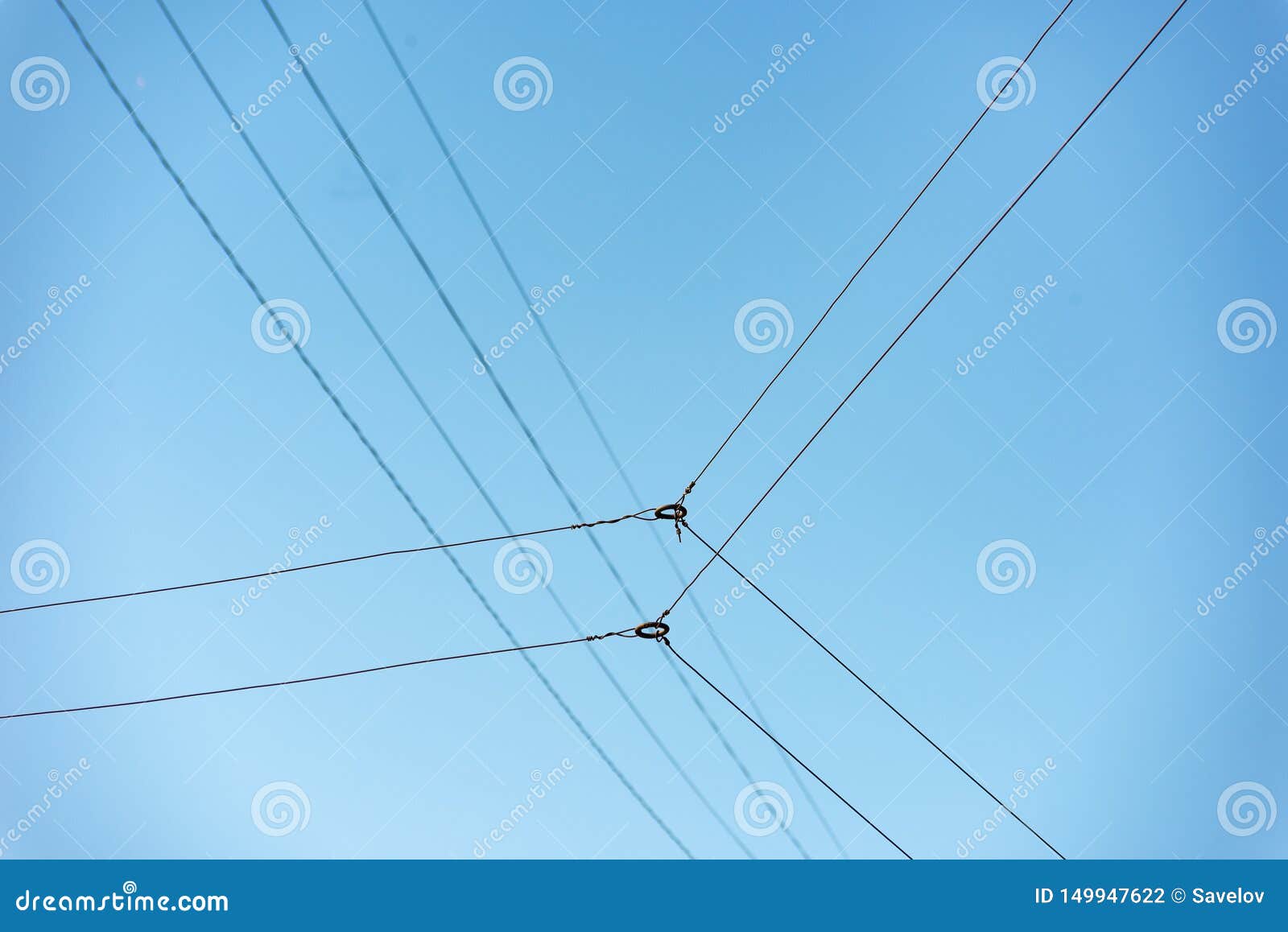 Intersecting Wires with Metal Ring Against a Blue Sky Stock Photo ...