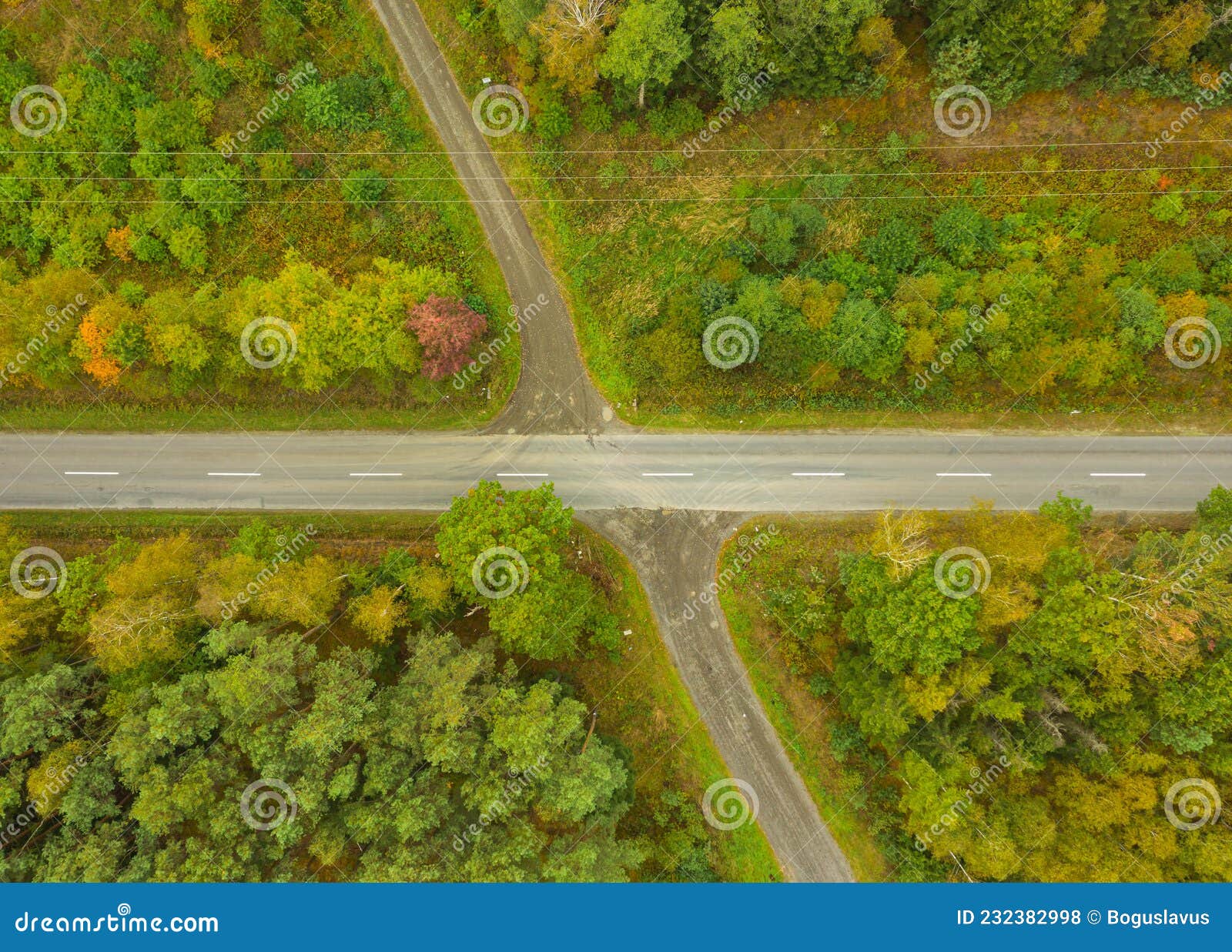 The Intersection of an Asphalt Road with a Forest Road. View from the ...