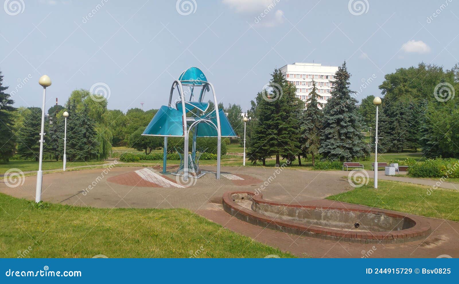 At the Intersection of Tiled Walkways in the City Park is a Composition ...