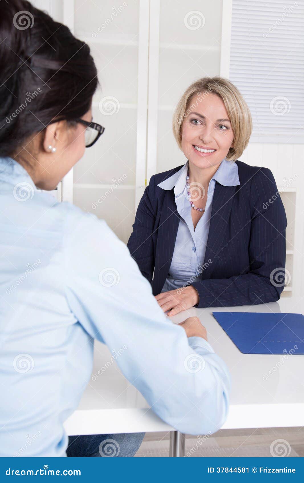 Interview with Two Businesswomen at Desk at Office. Stock Image - Image ...