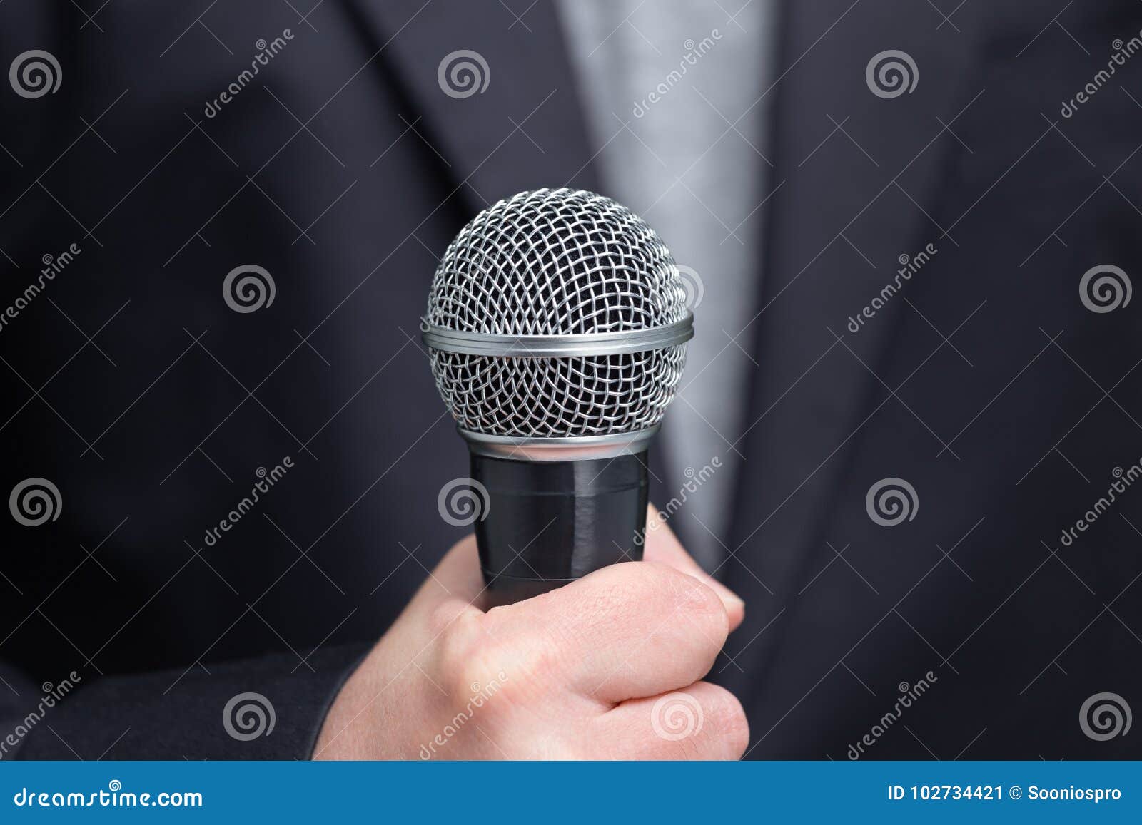 Interviewer or Reporter with Microphone in Hand in Foreground, M Stock ...