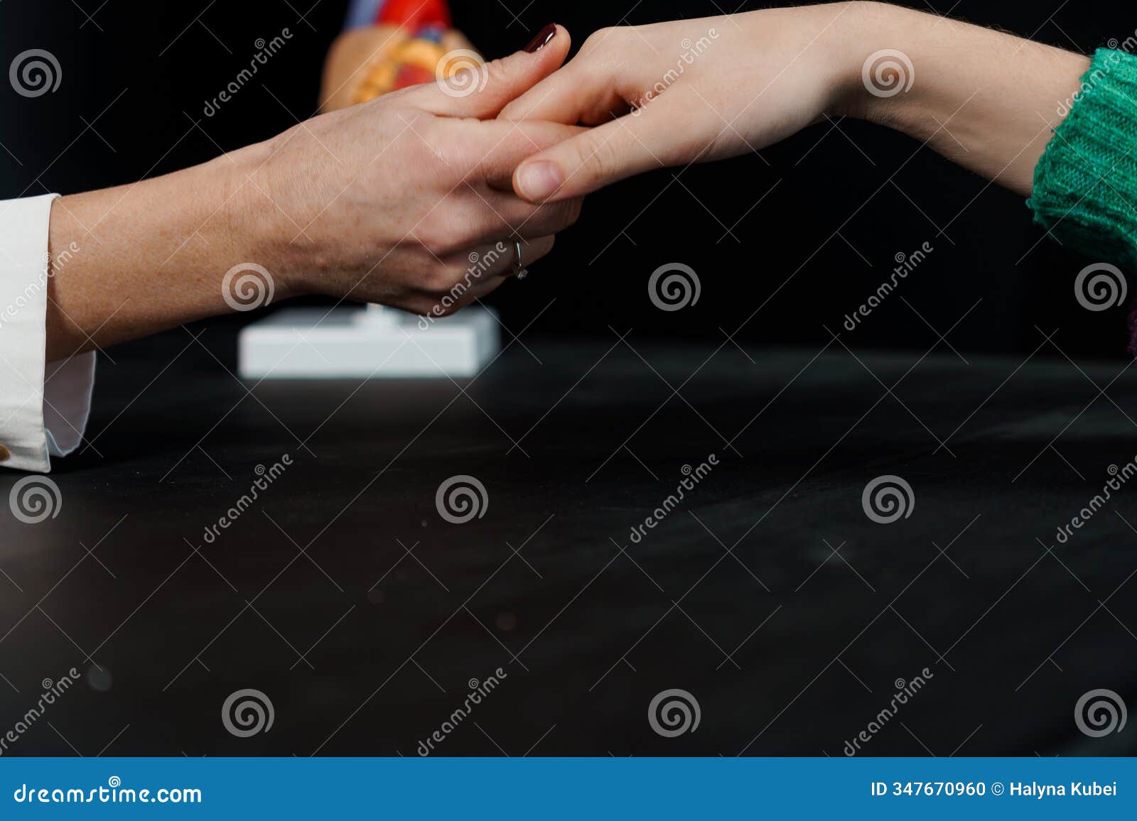 Intimate Connection: Two Hands Engaging in a Compassionate Touch Over a ...